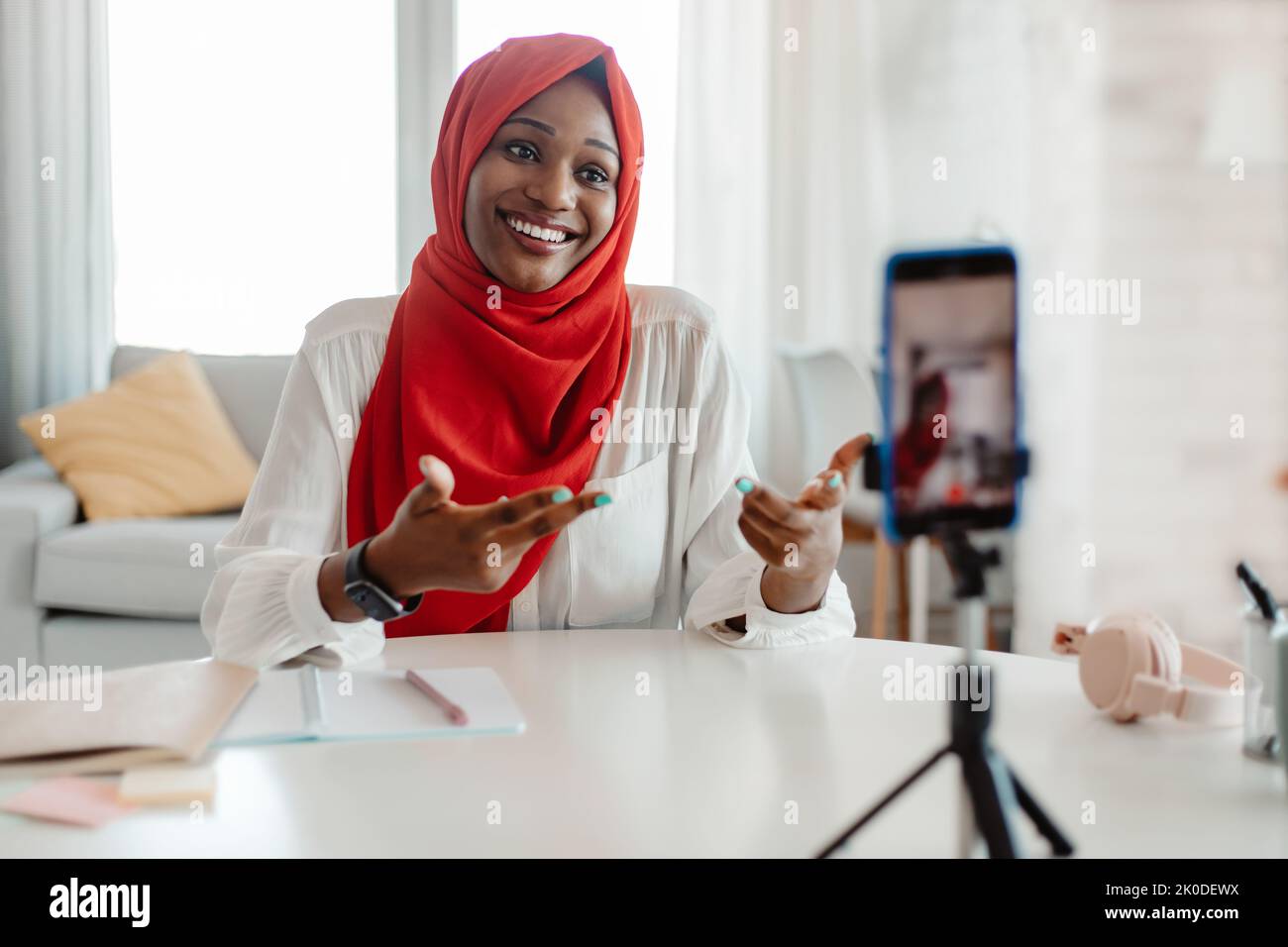 Happy african american islamic woman in hijab recording new video vlog ...