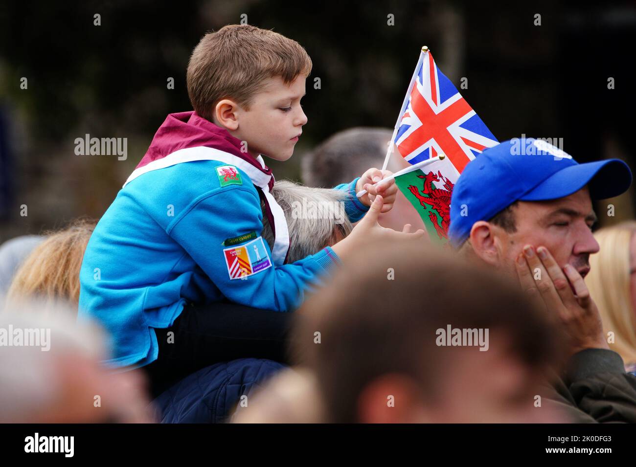 A young boy in a Scouts uniform holds a Union flag at the Accession ...
