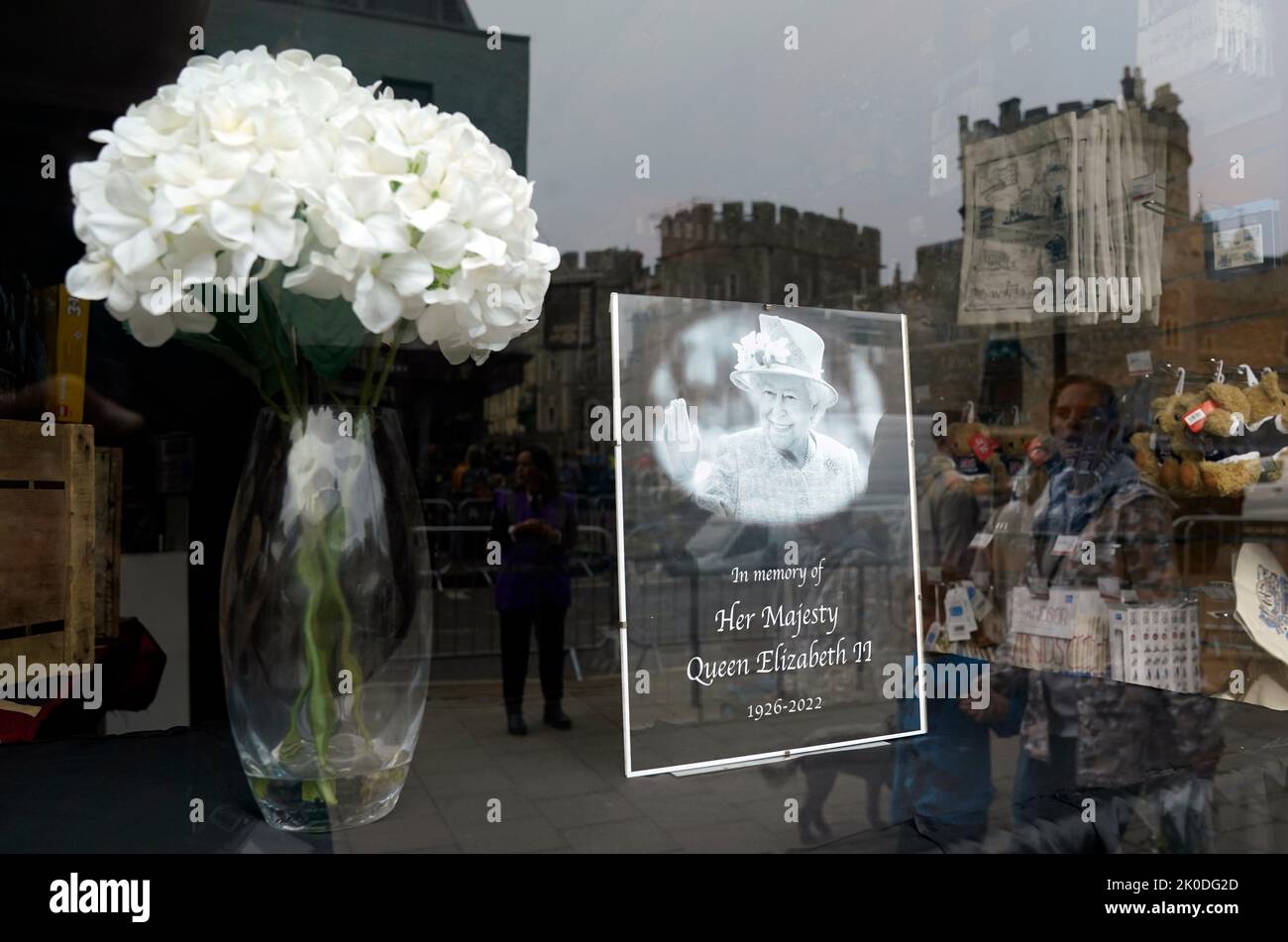 A photograph in memory of Queen Elizabeth II seen in the window of a ...