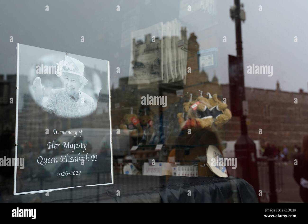 A photograph in memory of Queen Elizabeth II seen in the window of a ...