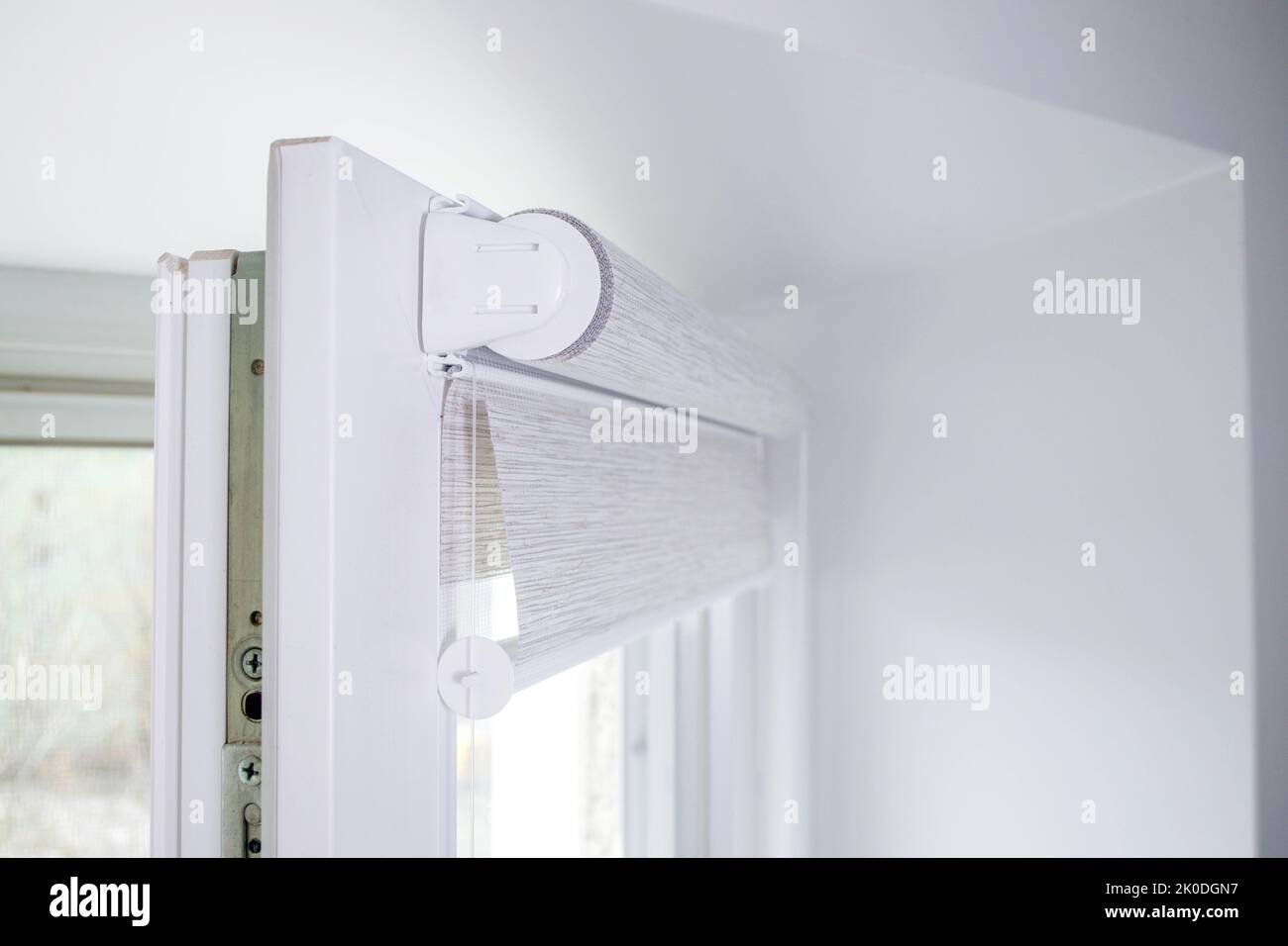 Close up mechanism of tnaninny roller blinds indoors. Duo window roller ...