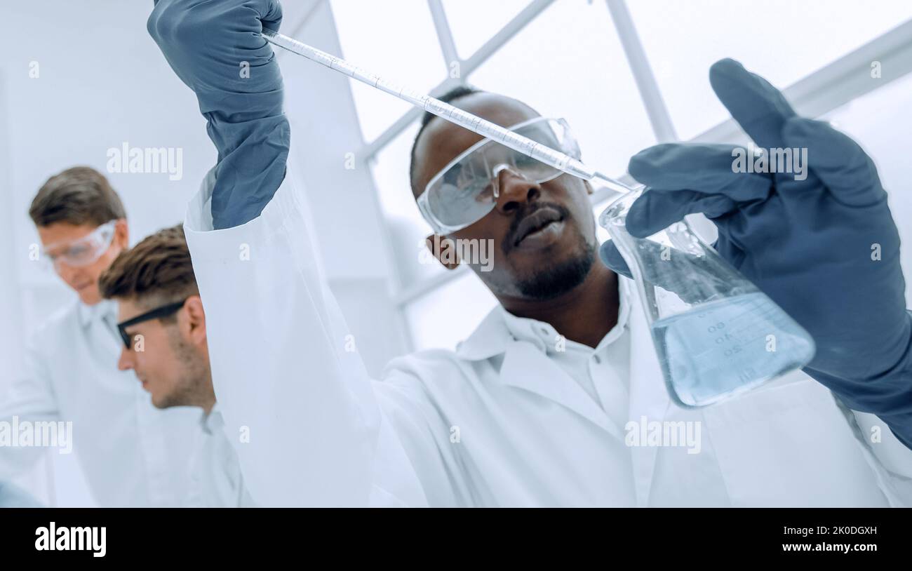 male scientist with a flask makes a test in the laboratory Stock Photo ...