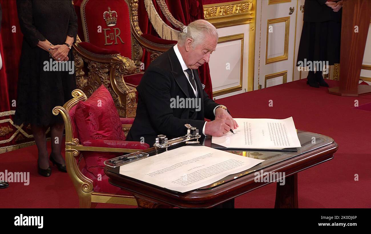 Pic shows: King Charles signs with a grimace at the footman to move the ...