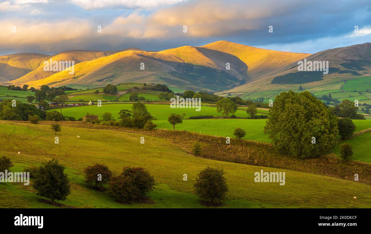 View of the small village Sedbergh. Sunset over green hills in ...