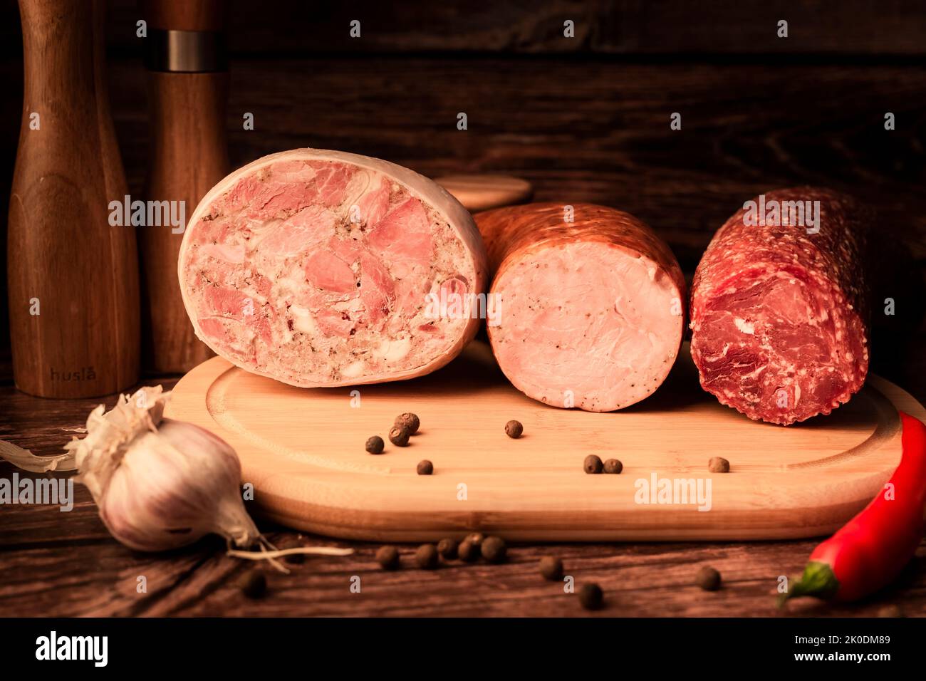 Meat on a wooden table with addition of fresh herbs and aromatic spices ...