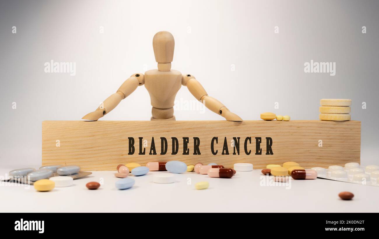 Bladder cancer written on wooden surface. Wooden man and medicine ...