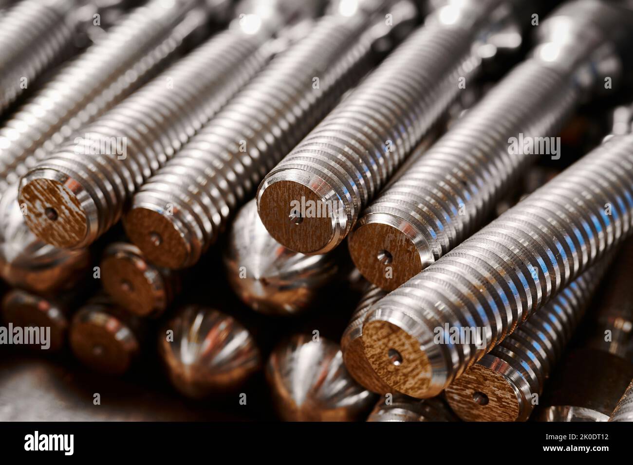 Large shiny bolts stack in plant warehouse macro view Stock Photo - Alamy