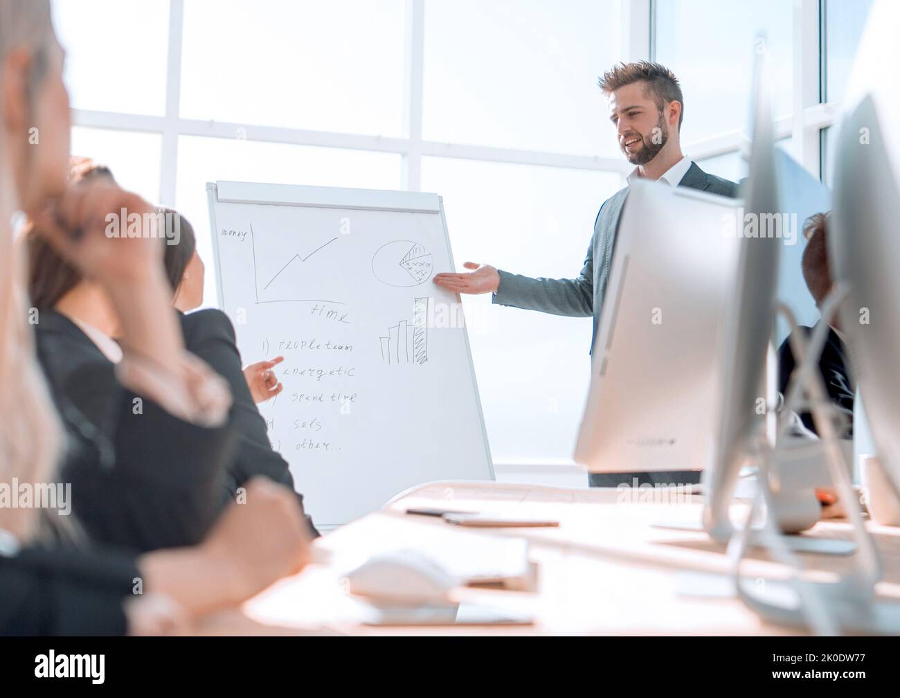 Manager and staff discussing a new presentation Stock Photo - Alamy