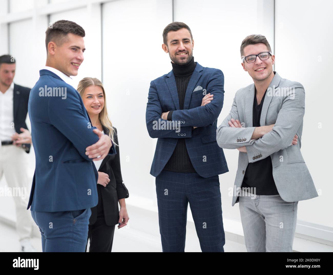 group of young employees standing in the office Stock Photo - Alamy