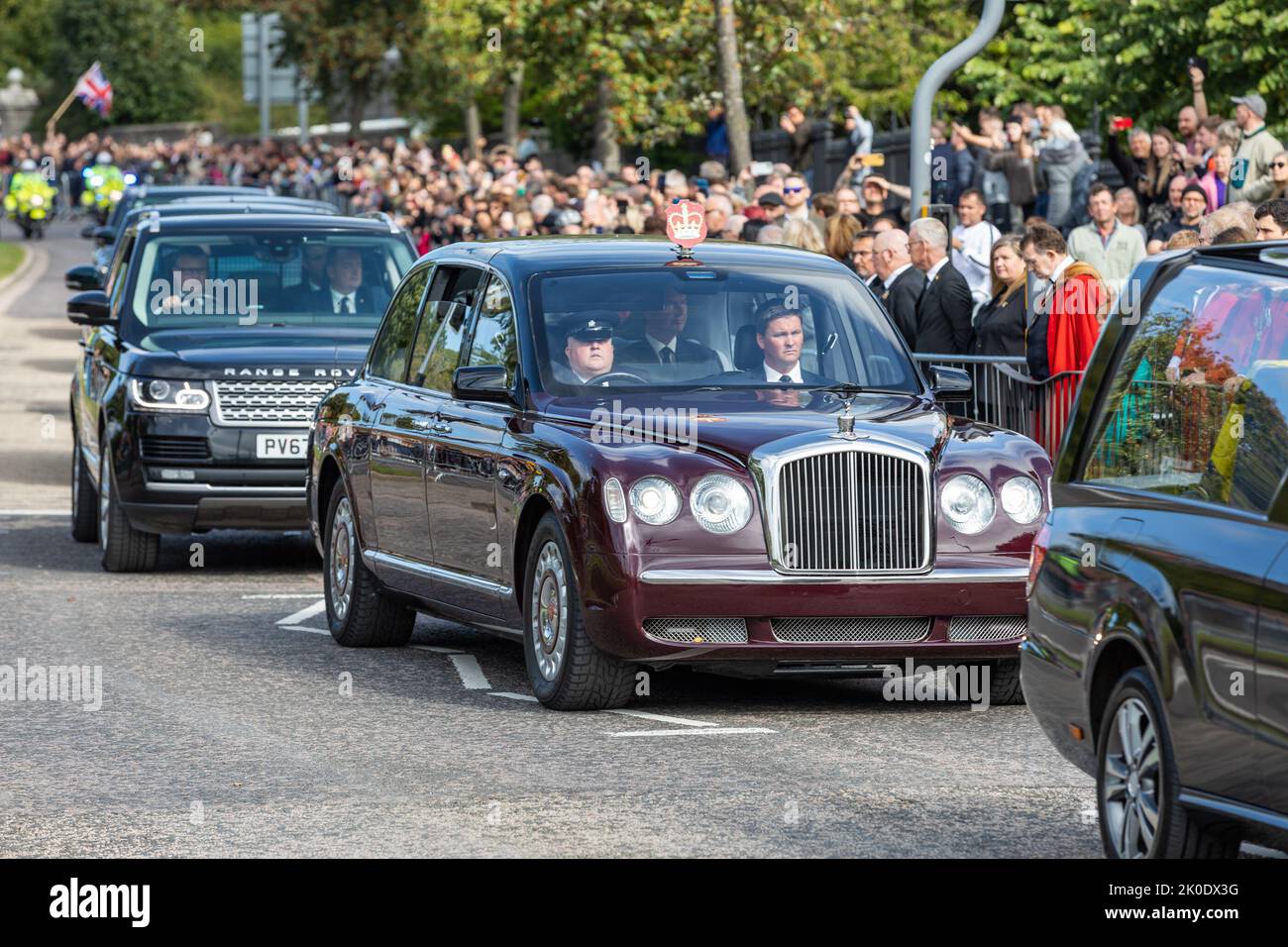The funeral cortege travels behind the hearse carrying the coffin of ...
