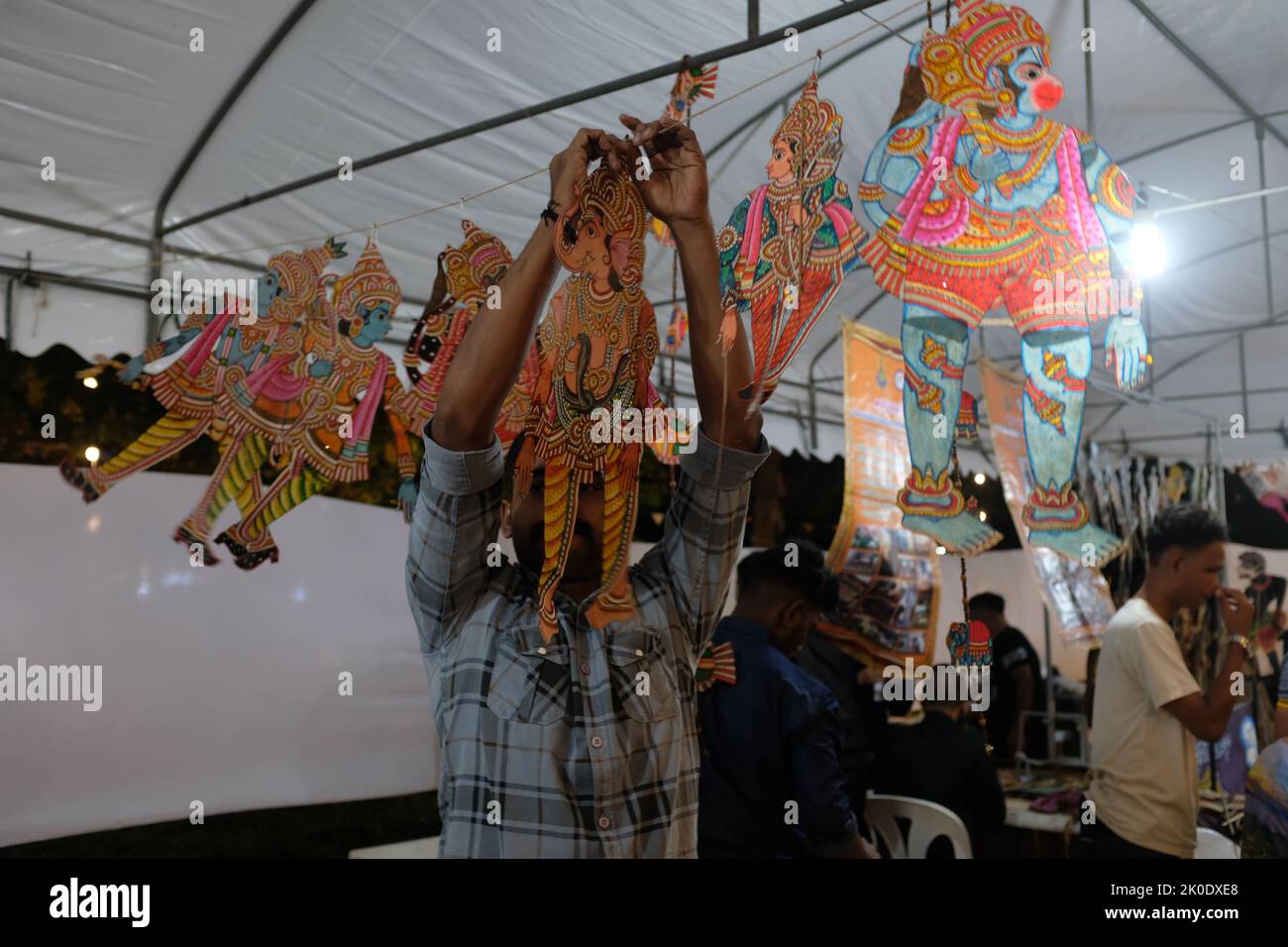Phetchaburi, Thailand. 10th Sep, 2022. An exhibitor puts his shadow puppet works in place during ...