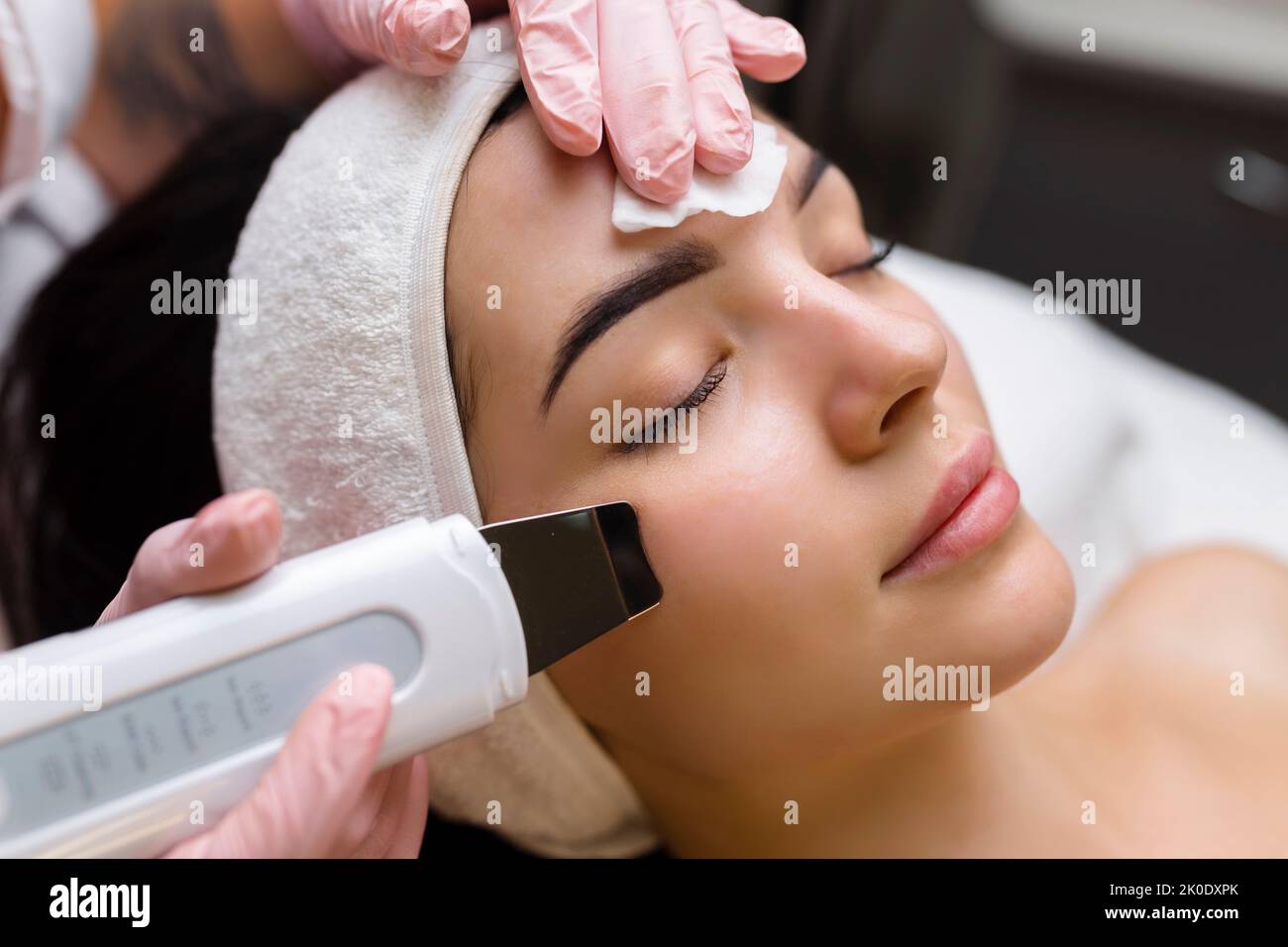 Facial cleansing with ultrasound scrubber. Woman receiving ultrasound ...