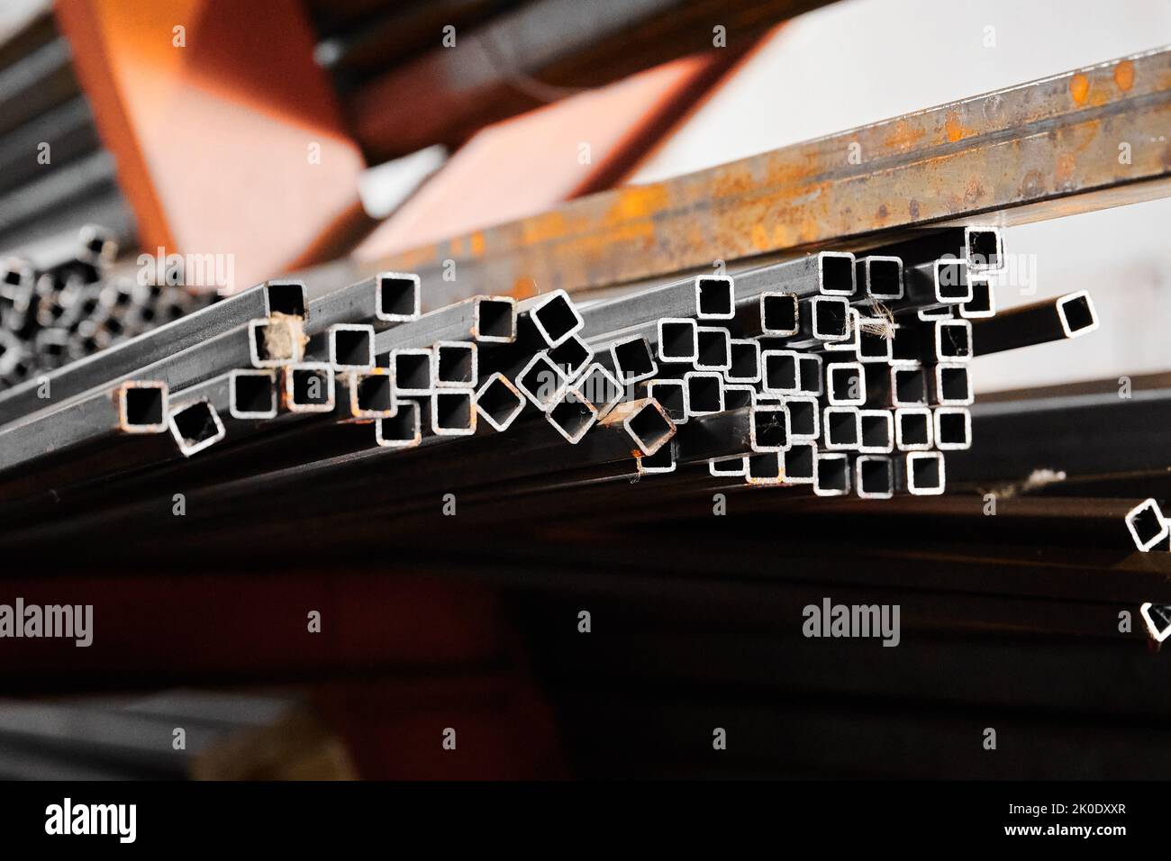 Square tubing on blurred background in cold warehouse Stock Photo - Alamy