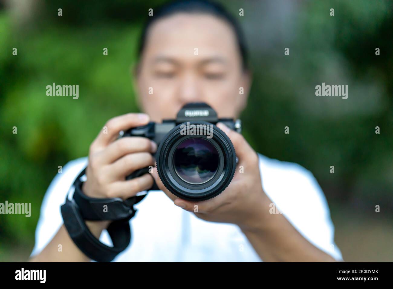 Asian man holds the Medium Format Camera in his hand and focus to shoot ...
