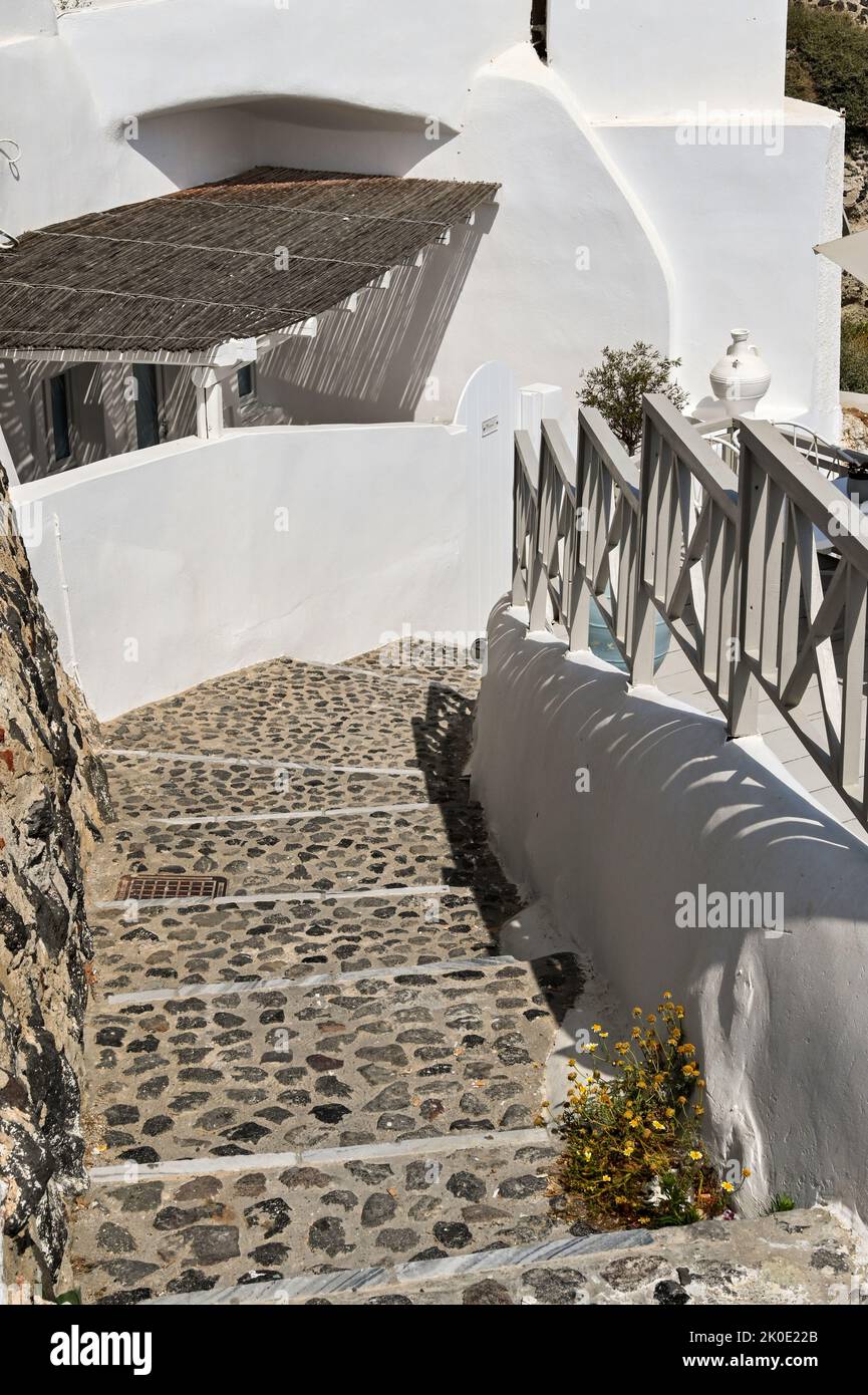 Oia, Santorini, Greece - June 2022: Steps on a narrow path leading down ...