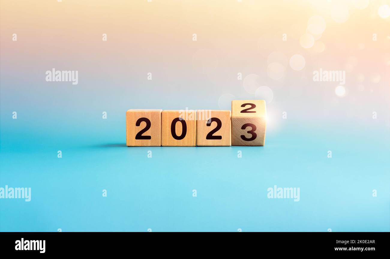 2023 happy new year concept banner. Flipping the 2022 to 2023 year numbers calendar on wooden ...