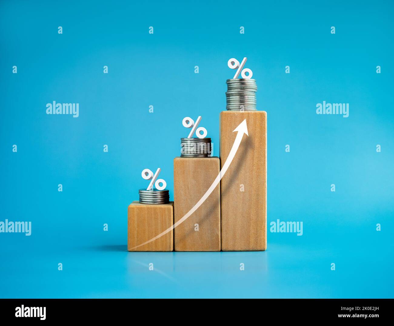 Shining rise up arrow on wooden cube blocks with percentage icon on ...