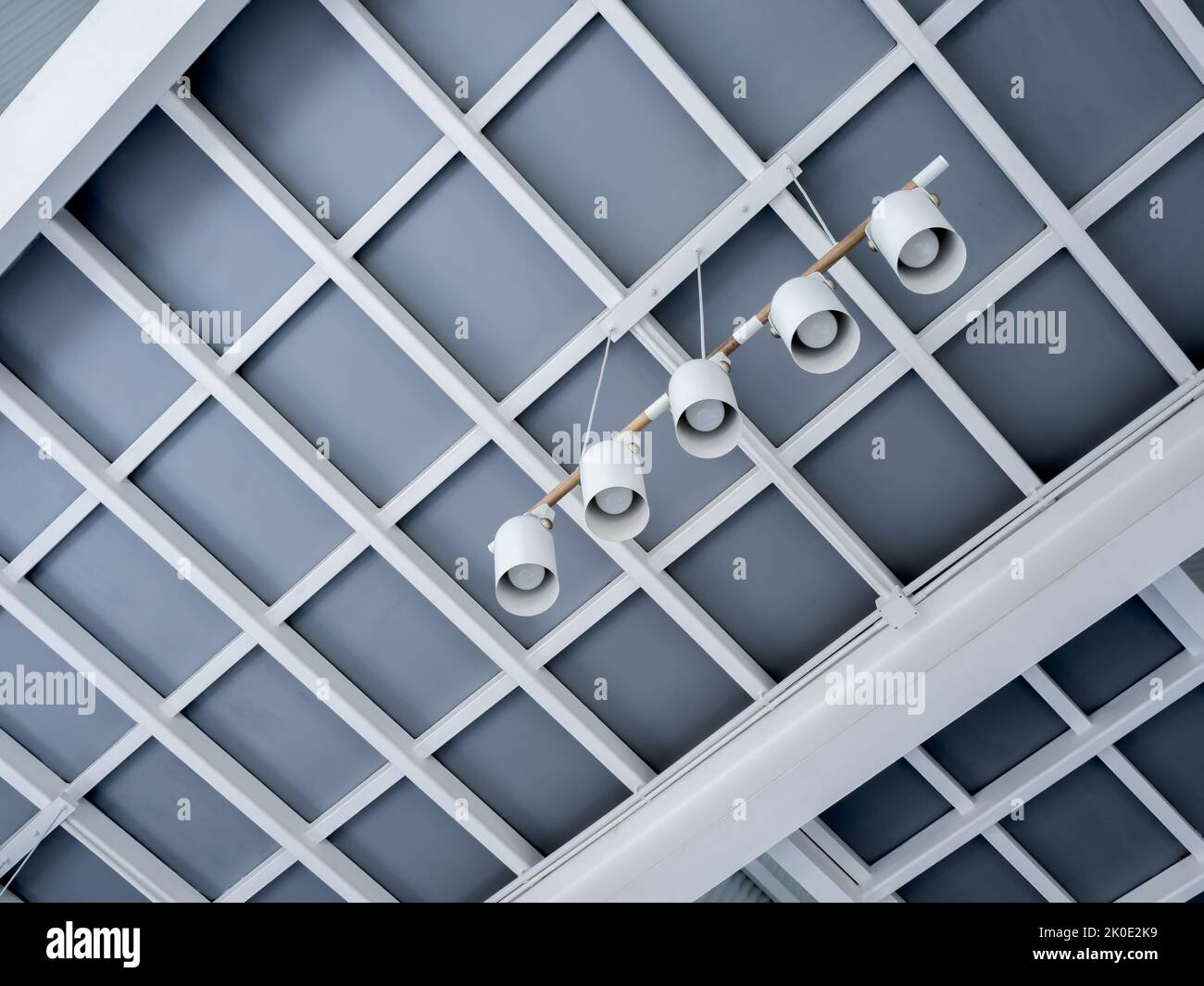 five spotlight hanging in cafe. Modern ceiling lamps set under the ...