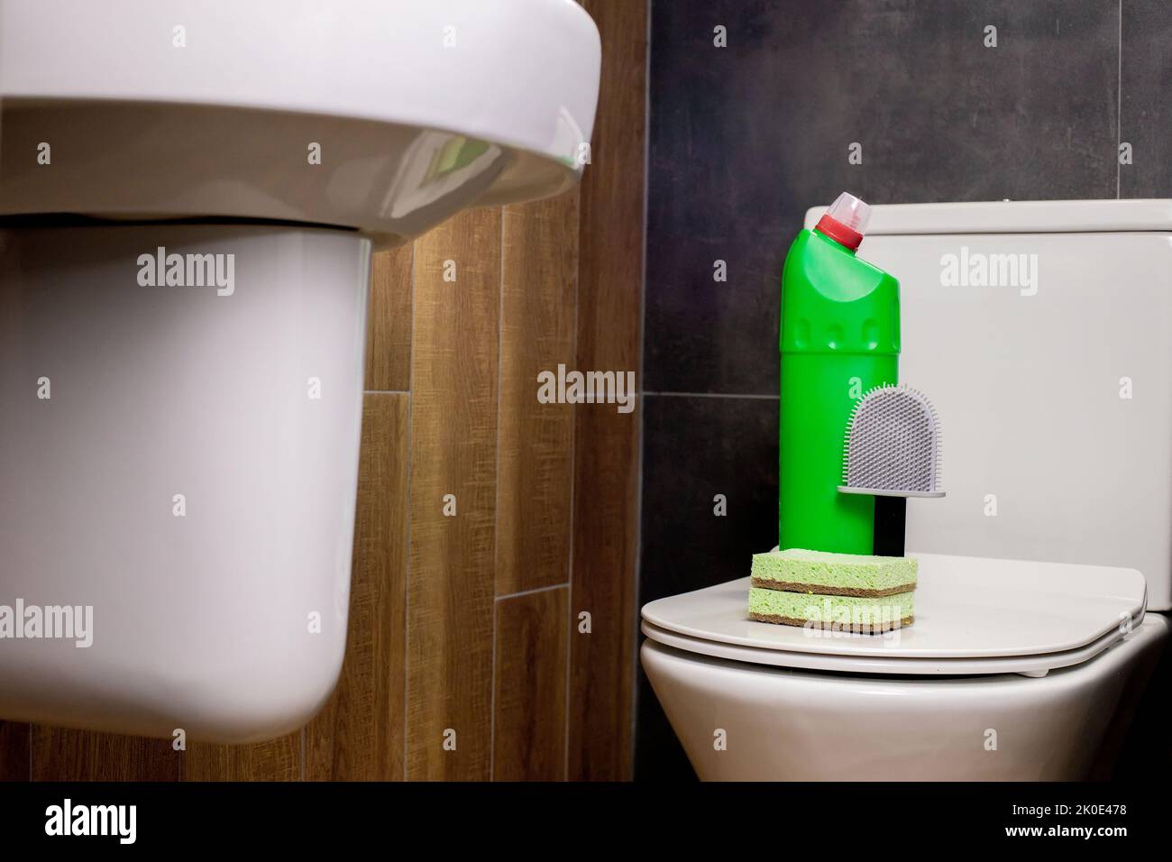 Toilet cleaner, a toilet brush and a washcloth on the toilet. Toilet ...