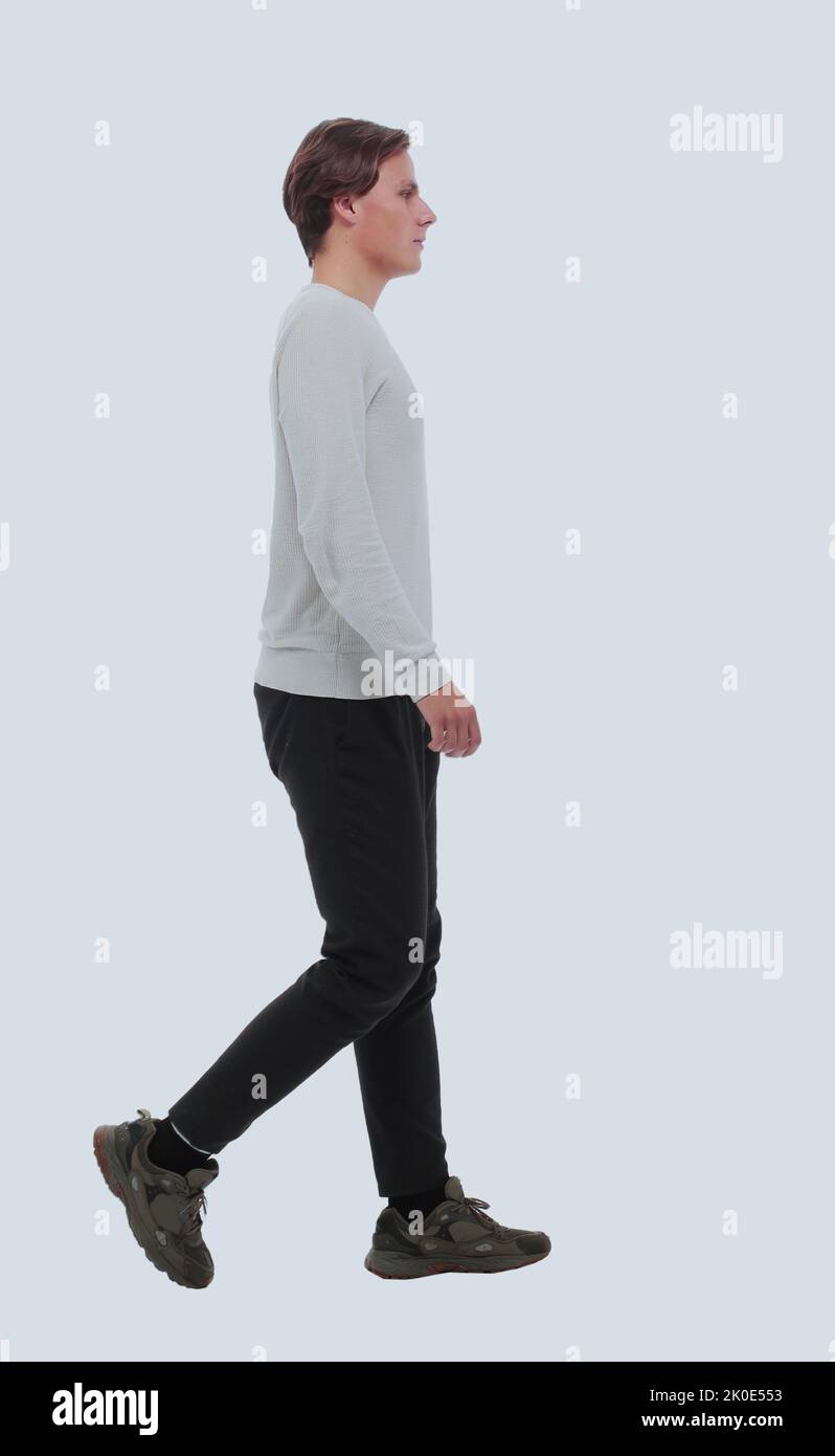 side view . modern young man stepping forward Stock Photo - Alamy