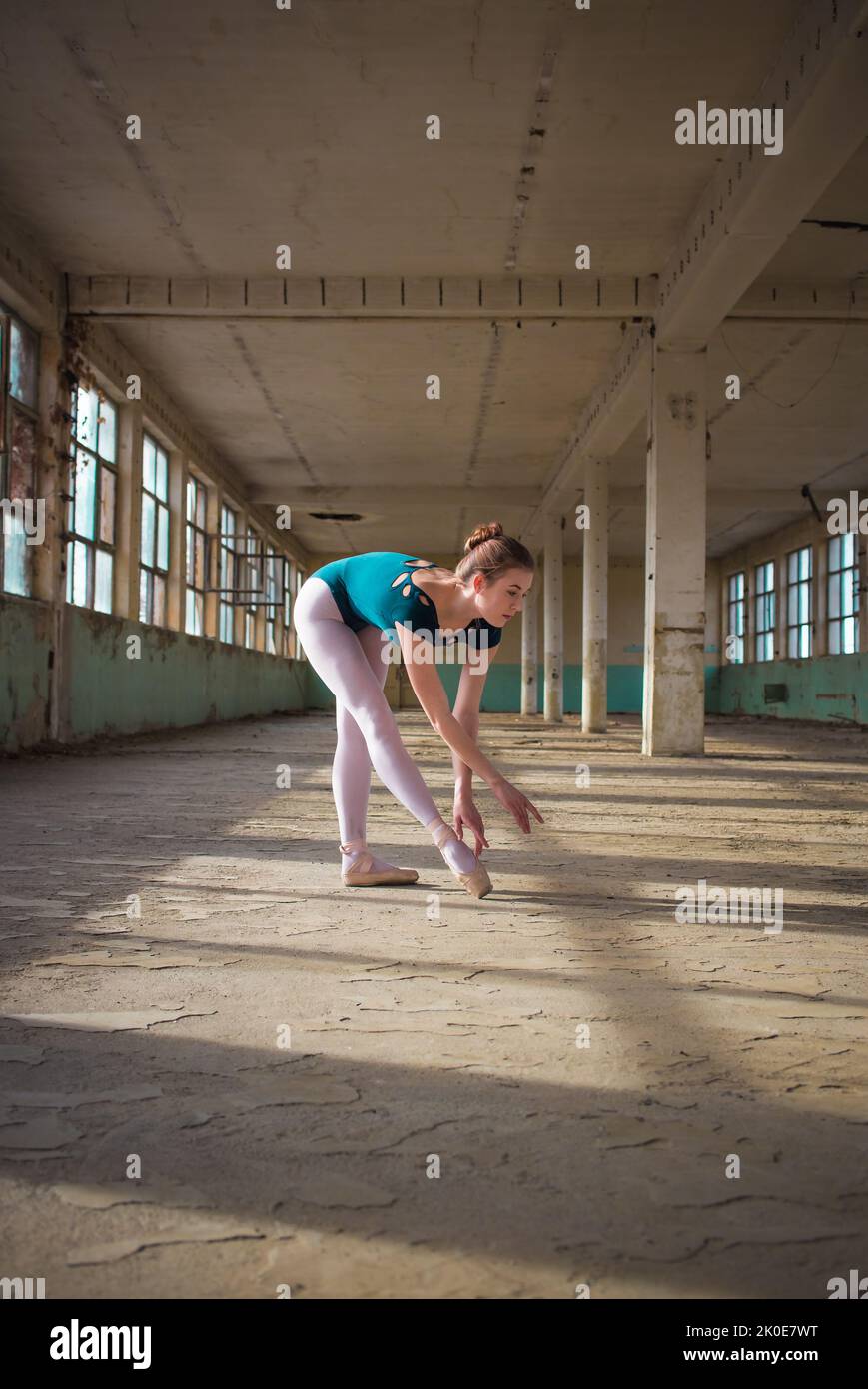 Ballerina dancing in an old building. Young, elegant, graceful woman ...