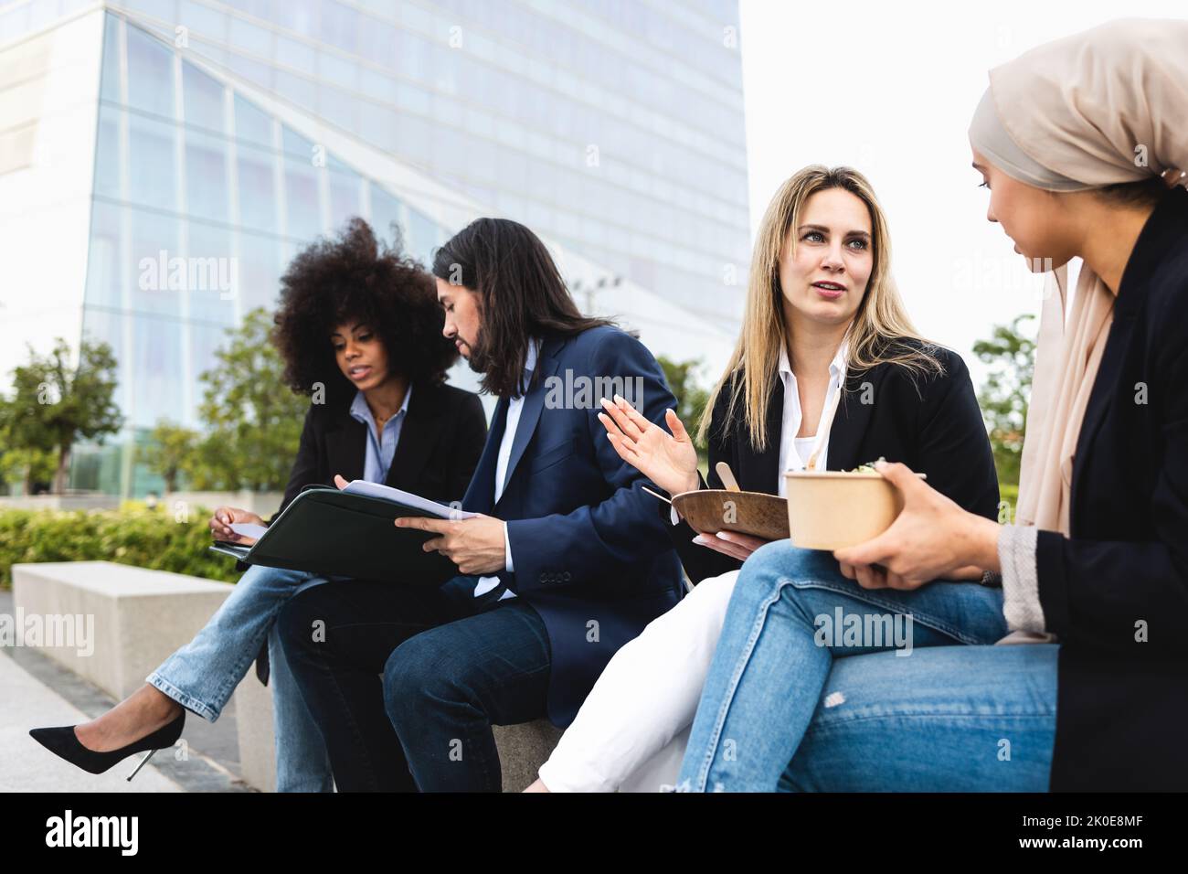 Multiracial business people having a lunch break outside office Stock ...
