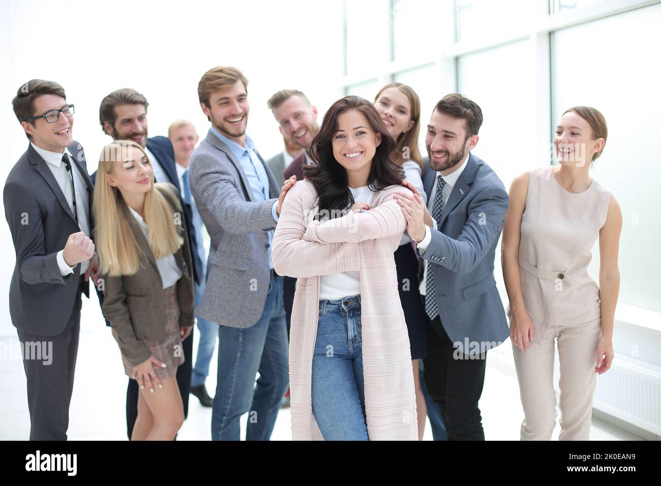 happy business team admiring their young leader Stock Photo - Alamy