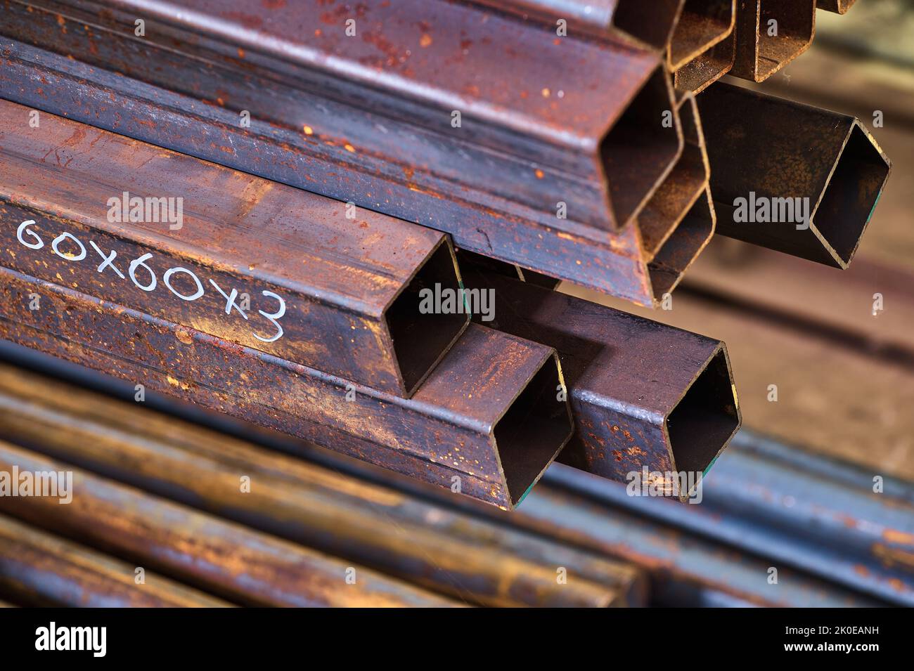 Square tubing on blurred background in cold warehouse Stock Photo - Alamy