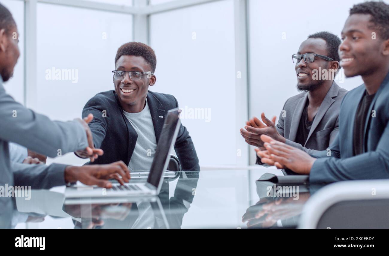 project Manager explaining something to employees at an office meeting ...