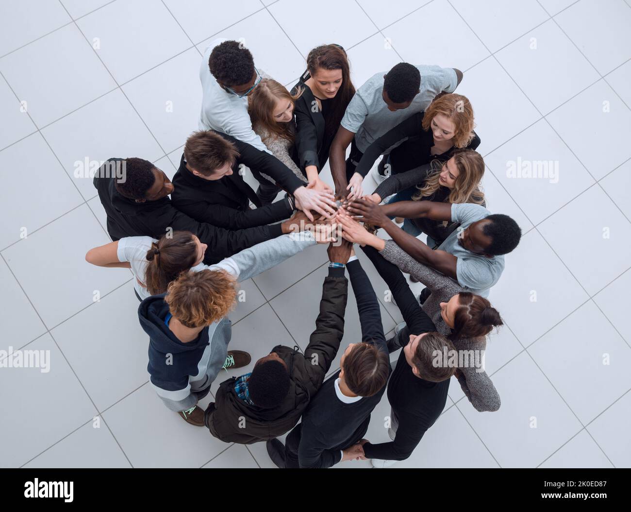 group of young successful people stands around hands together Stock ...