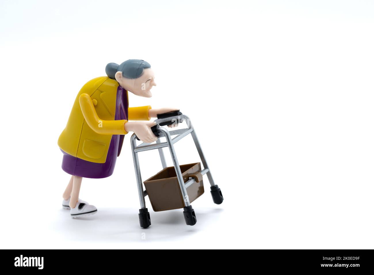 Grandmother with walker, toys, white background, cropped image Stock ...