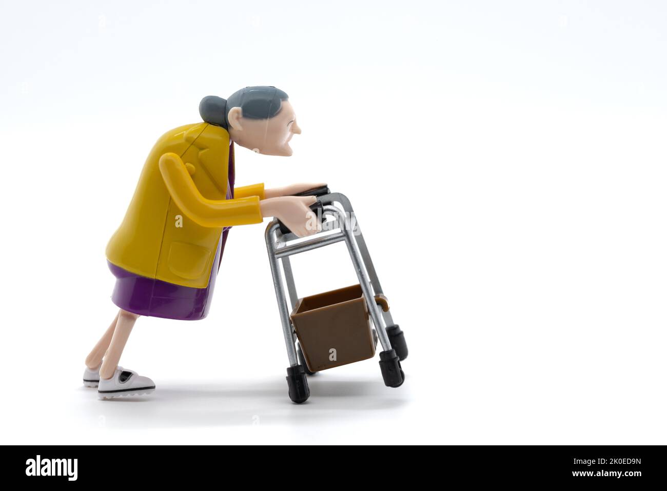 Grandmother with walker, toys, white background, cropped image Stock ...
