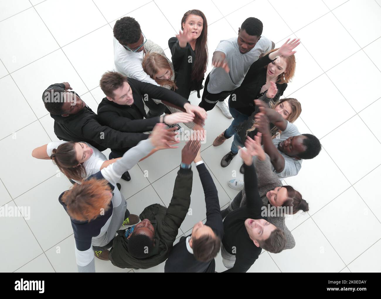 group of young successful people stands around hands together Stock ...