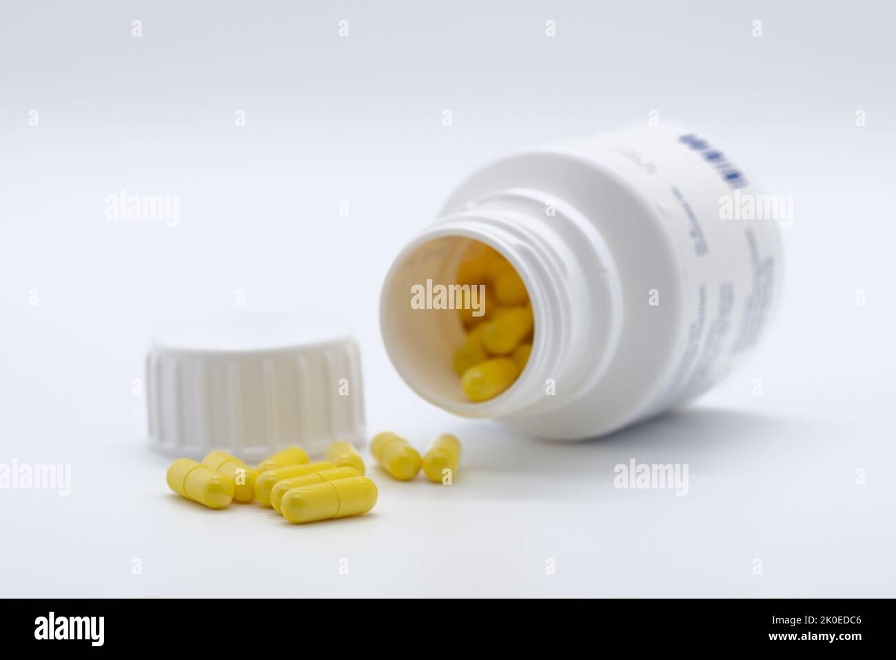 Pills in yellow color with pills can on white background, medicine ...