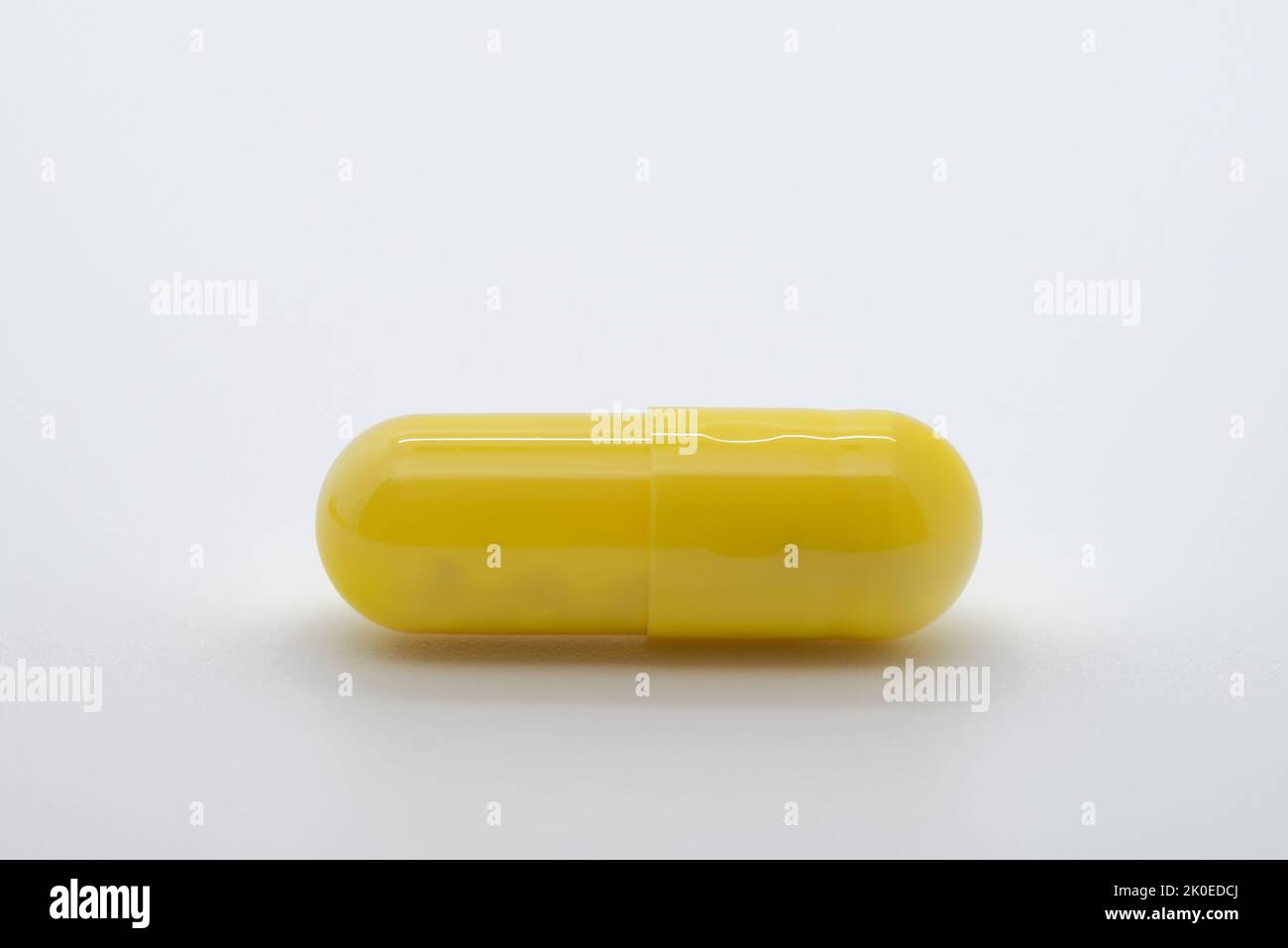 Pill in yellow color on white background, medicine, cropped image Stock ...
