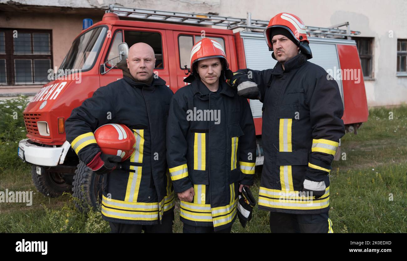 Group of fire fighters standing confident after a well done rescue ...