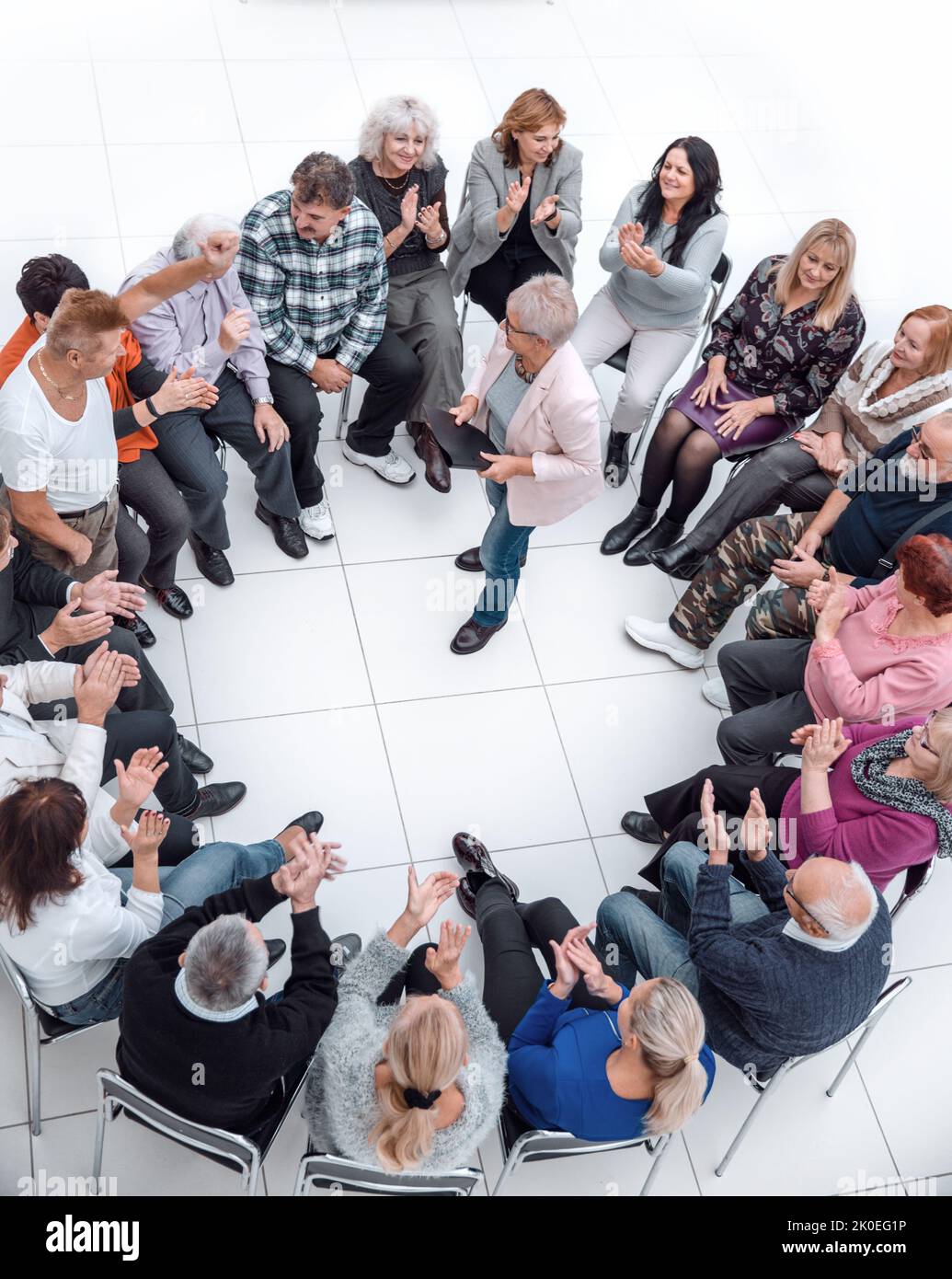 confident older woman standing in a circle of like-minded people Stock ...