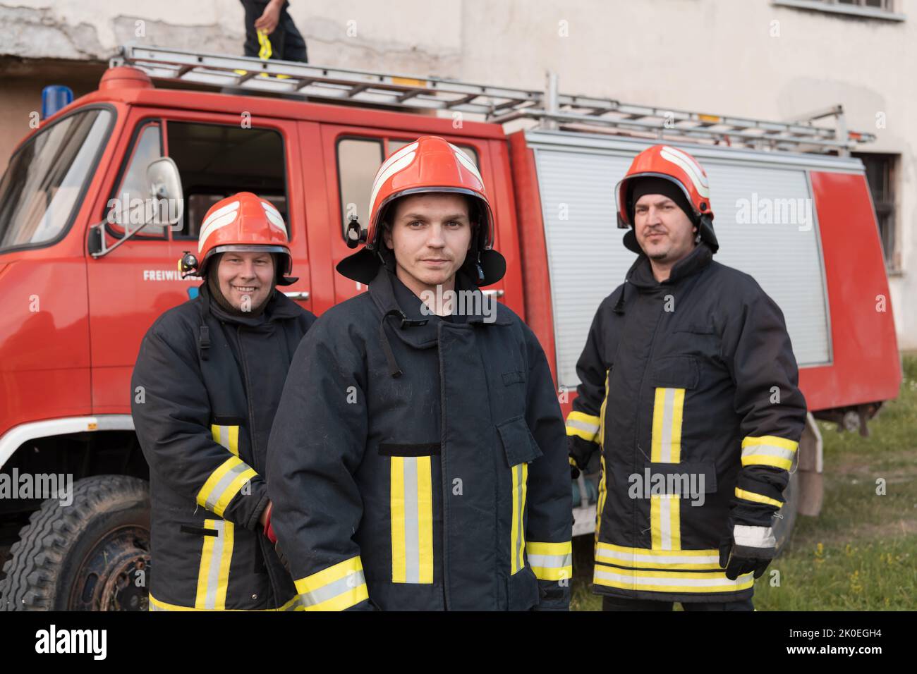 Group of fire fighters standing confident after a well done rescue ...