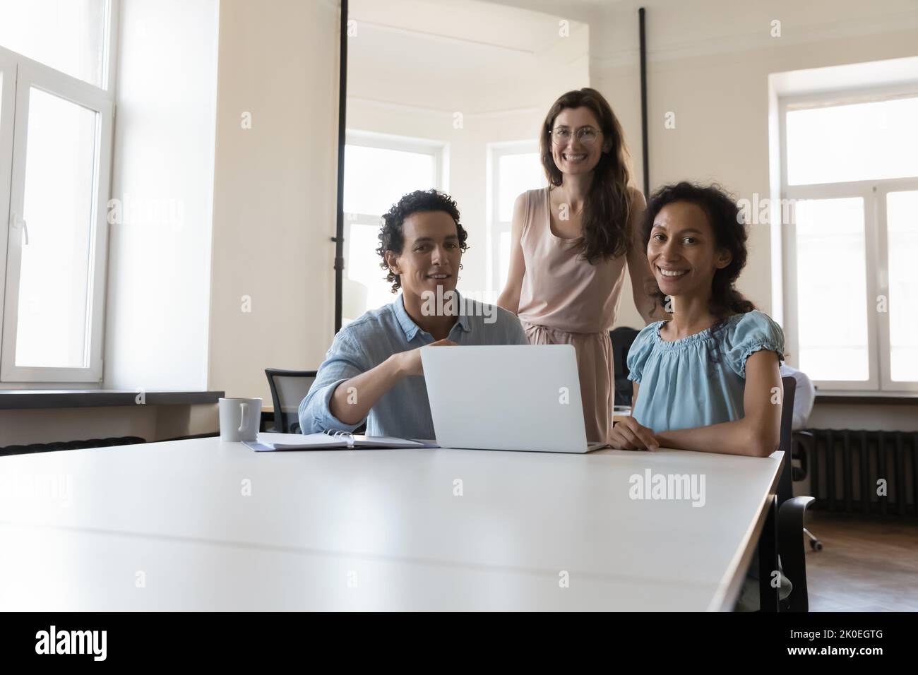 Happy successful business team posing at shared workplace Stock Photo ...