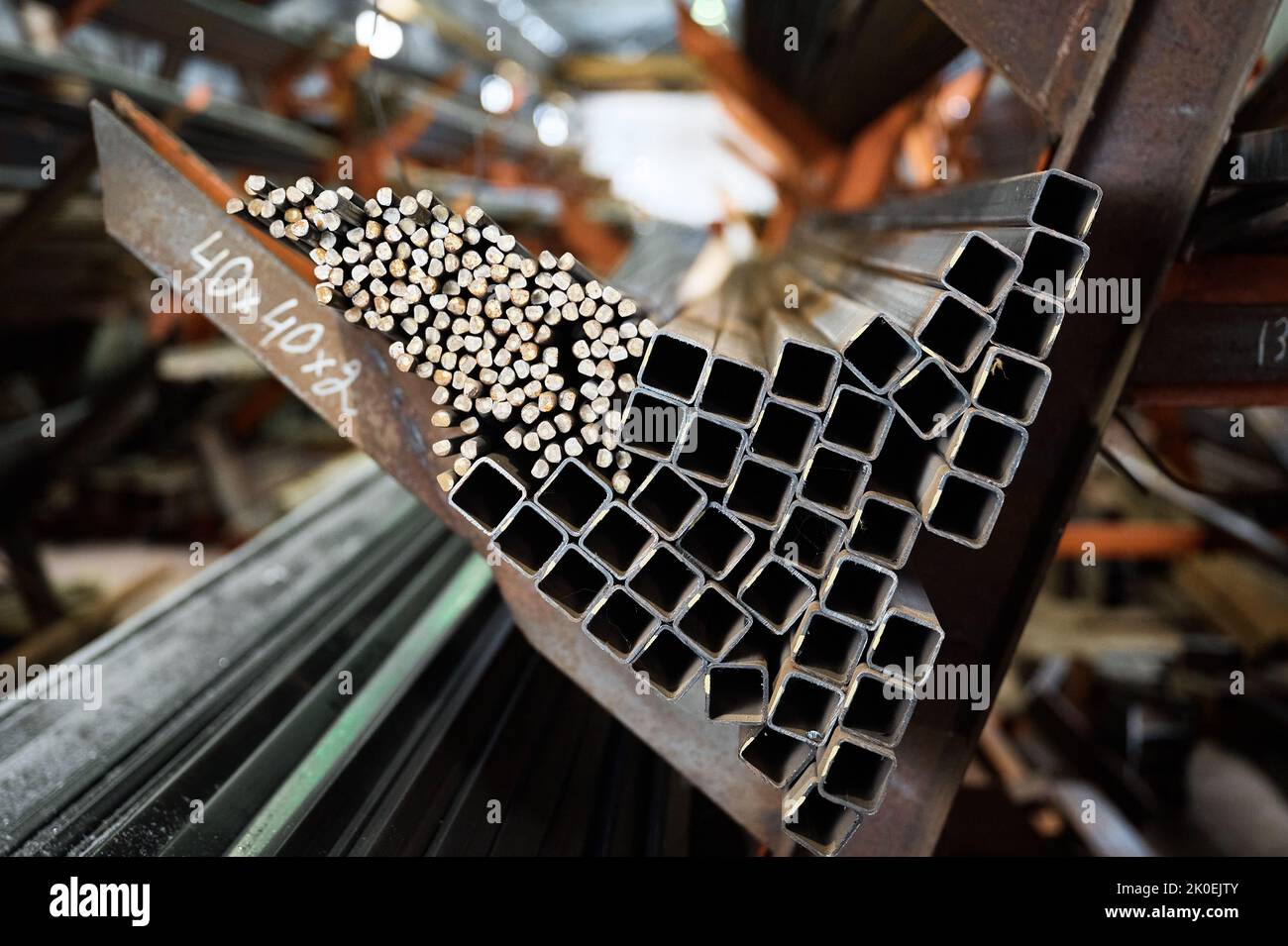 Square tubing pile on rack unit in cold factory warehouse Stock Photo ...
