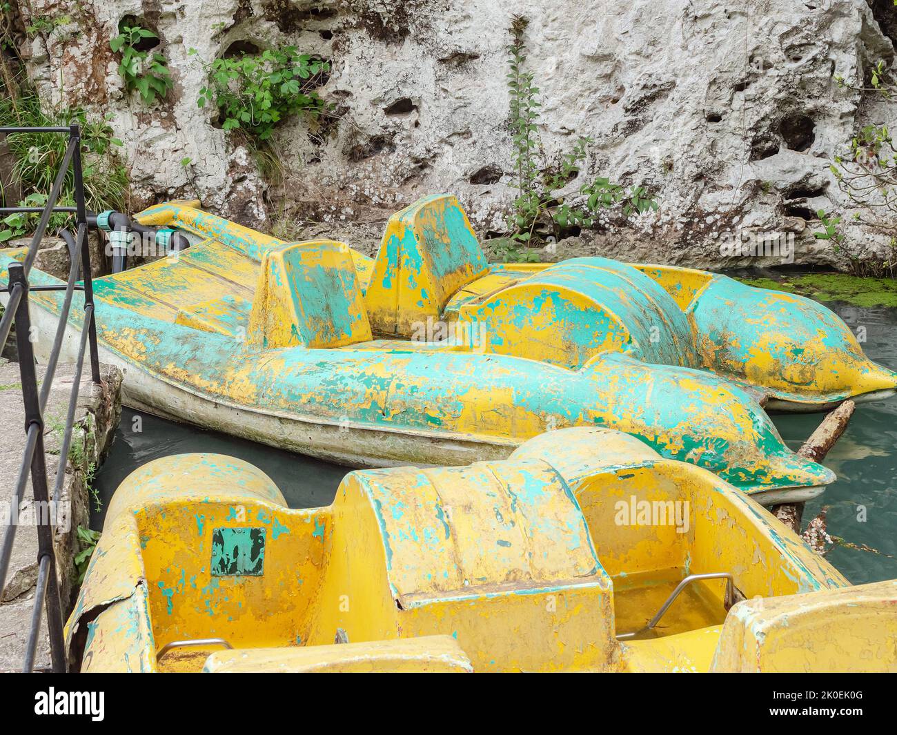 Peeling old catamaran in the river. Catamarans in the river near cliff ...