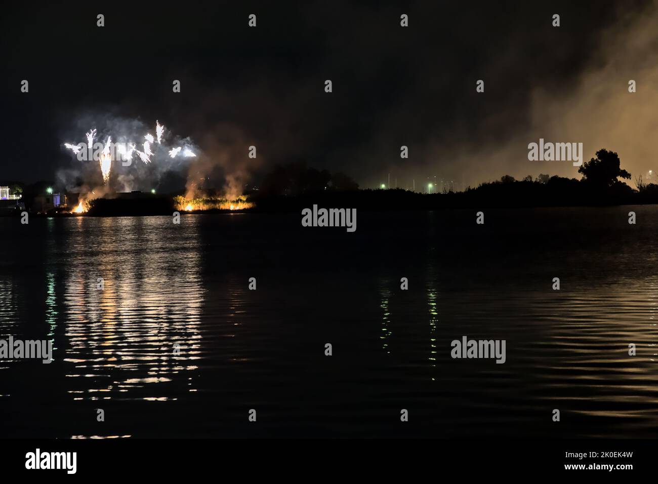 Fire on the shore of the lake, burning a lot of vegetation Stock Photo ...