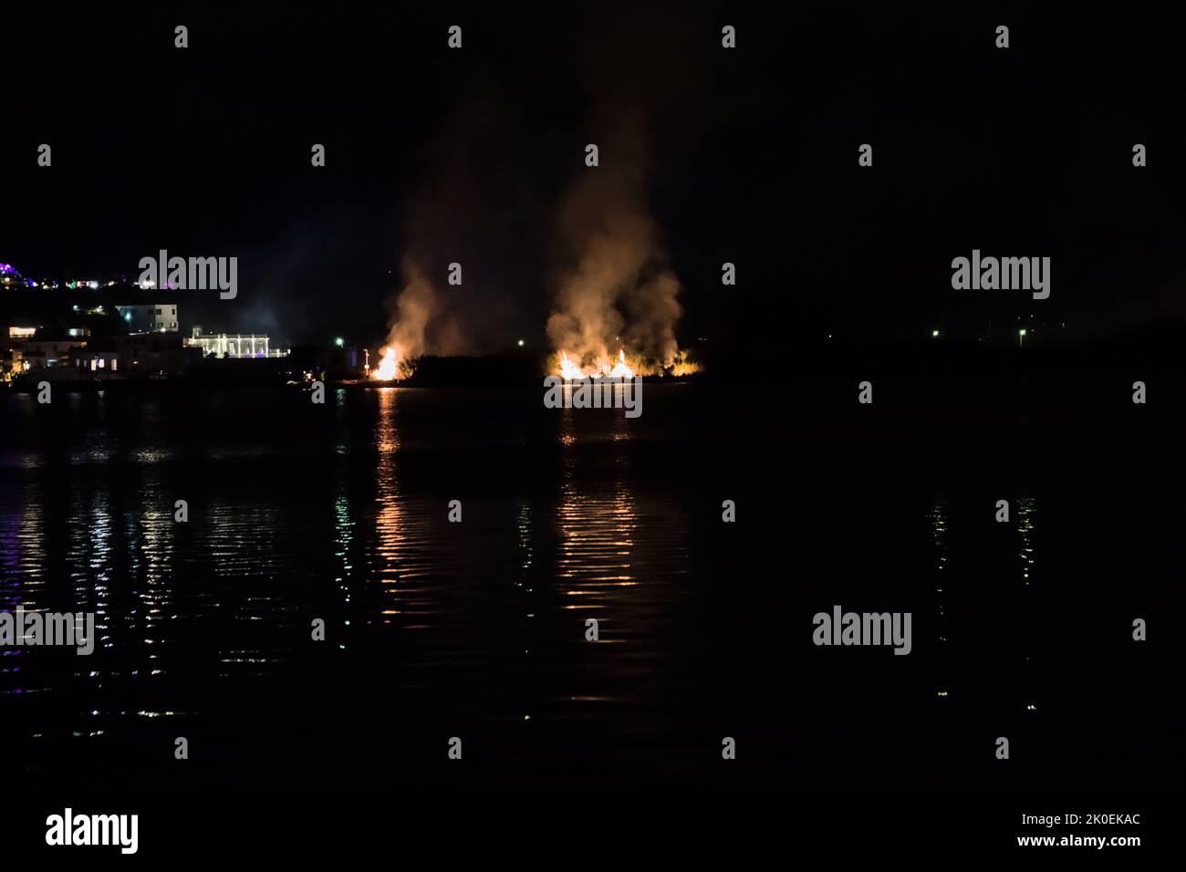 Fire on the shore of the lake, burning a lot of vegetation Stock Photo ...