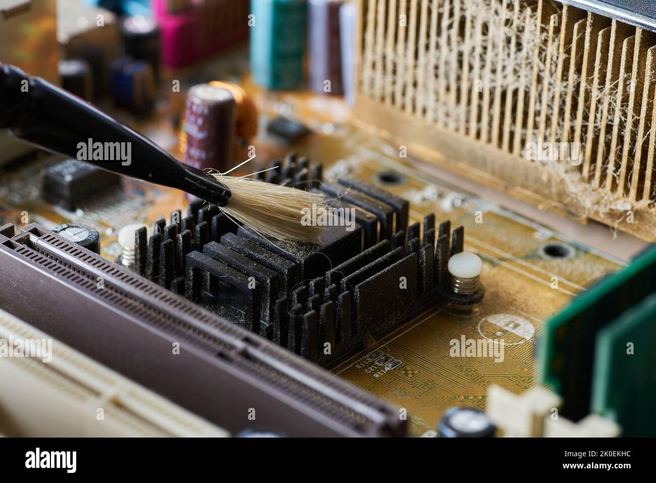 Brush cleaning an old computer board from dust and dirt. Close-up Stock ...