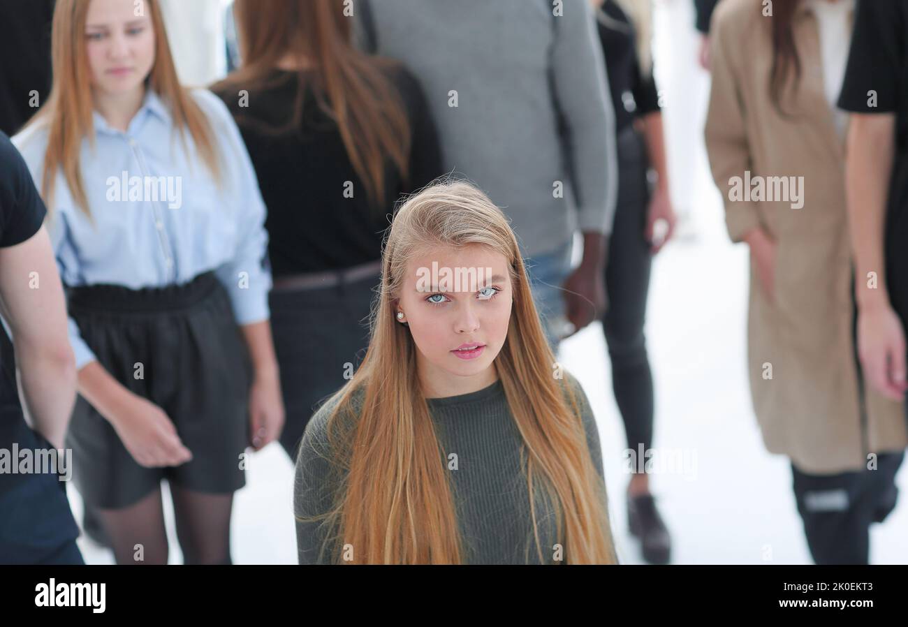 serious woman standing in front of casual group of young people Stock ...