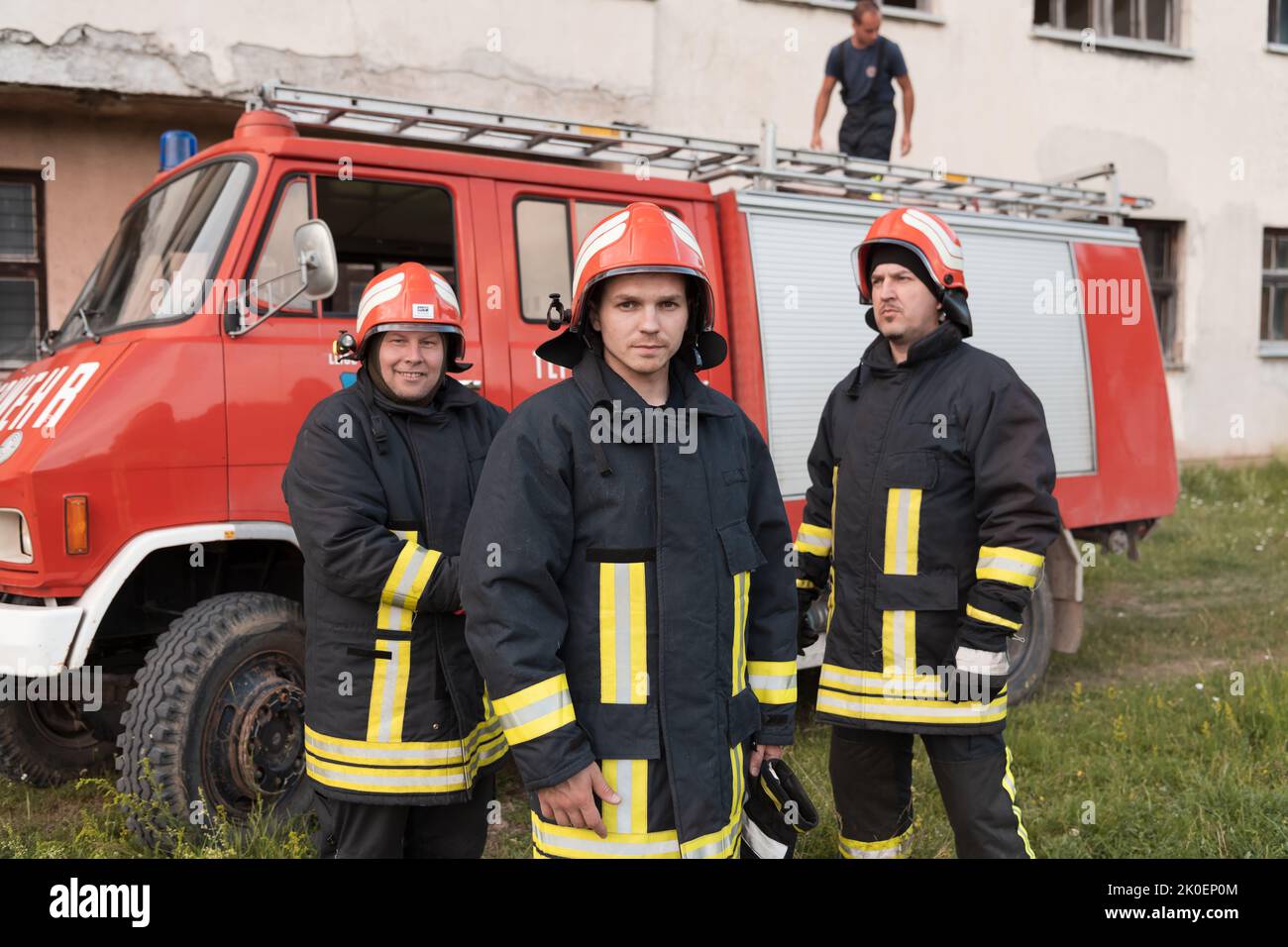 Group of fire fighters standing confident after a well done rescue ...