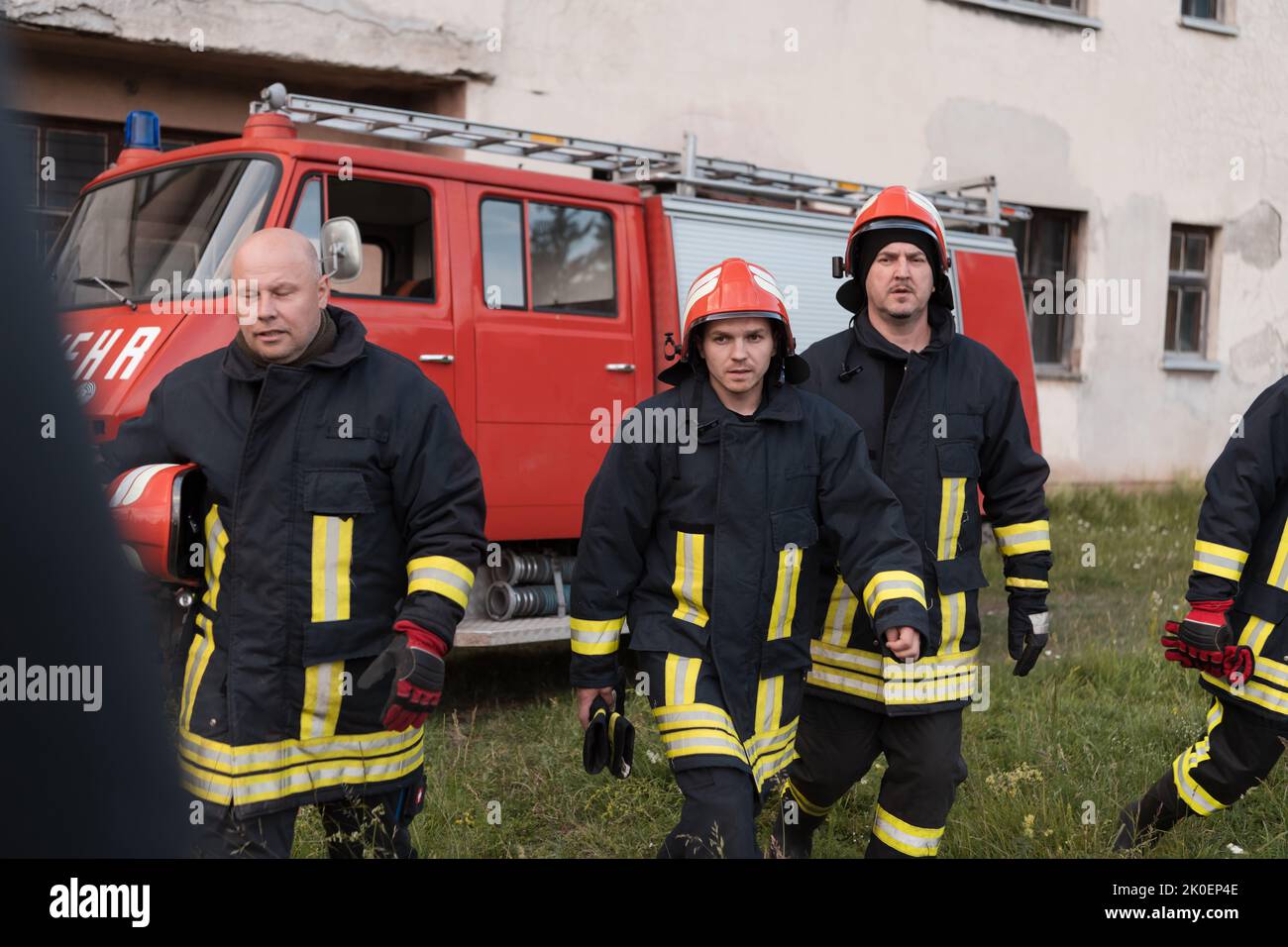 Group of fire fighters standing confident after a well done rescue ...