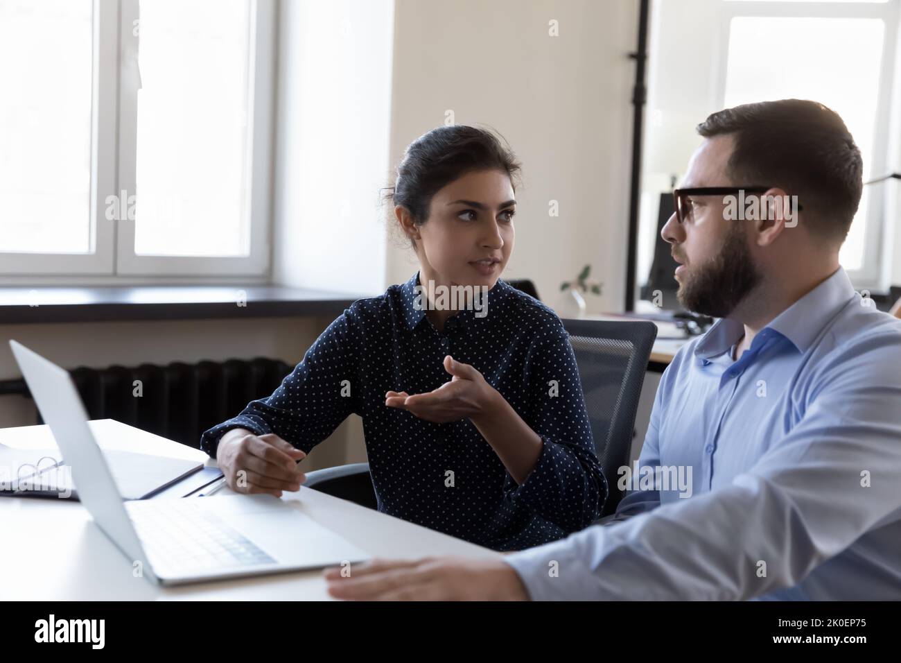 Two serious diverse employees discussing business project tasks Stock ...