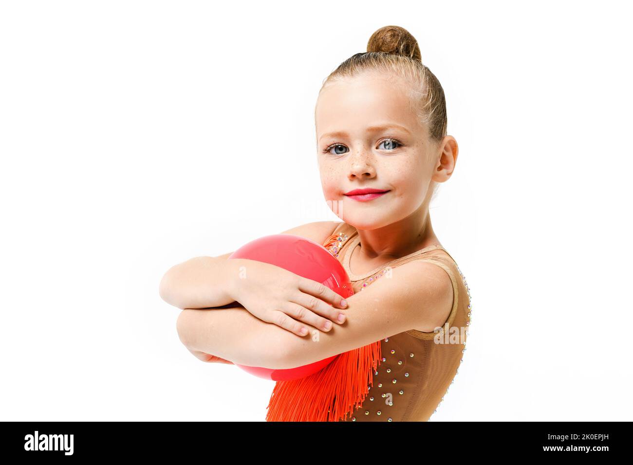 Little girl gymnast studio portrait with rubber ball, artistic ...