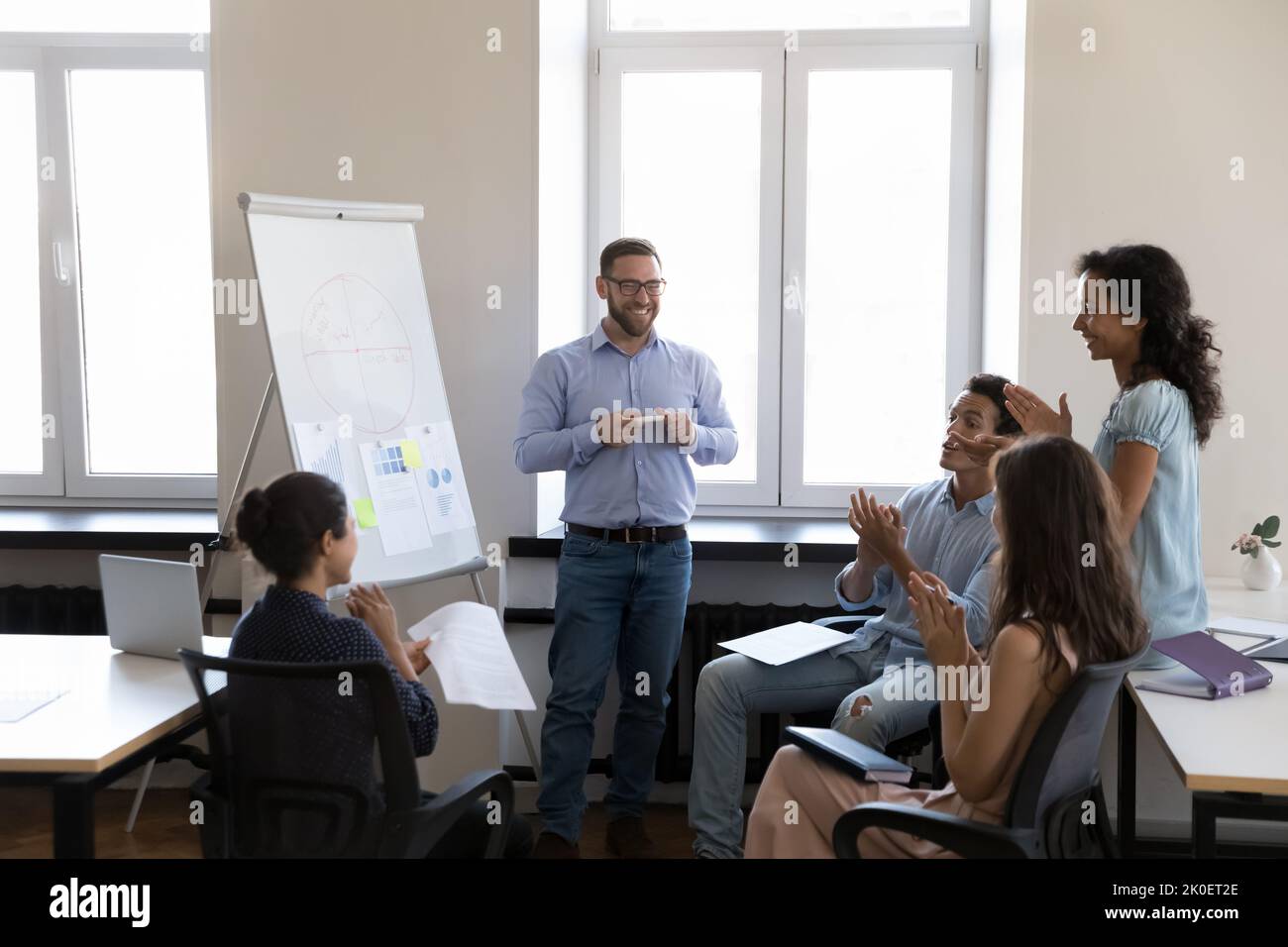 Happy satisfied business leader man getting applause from audience ...